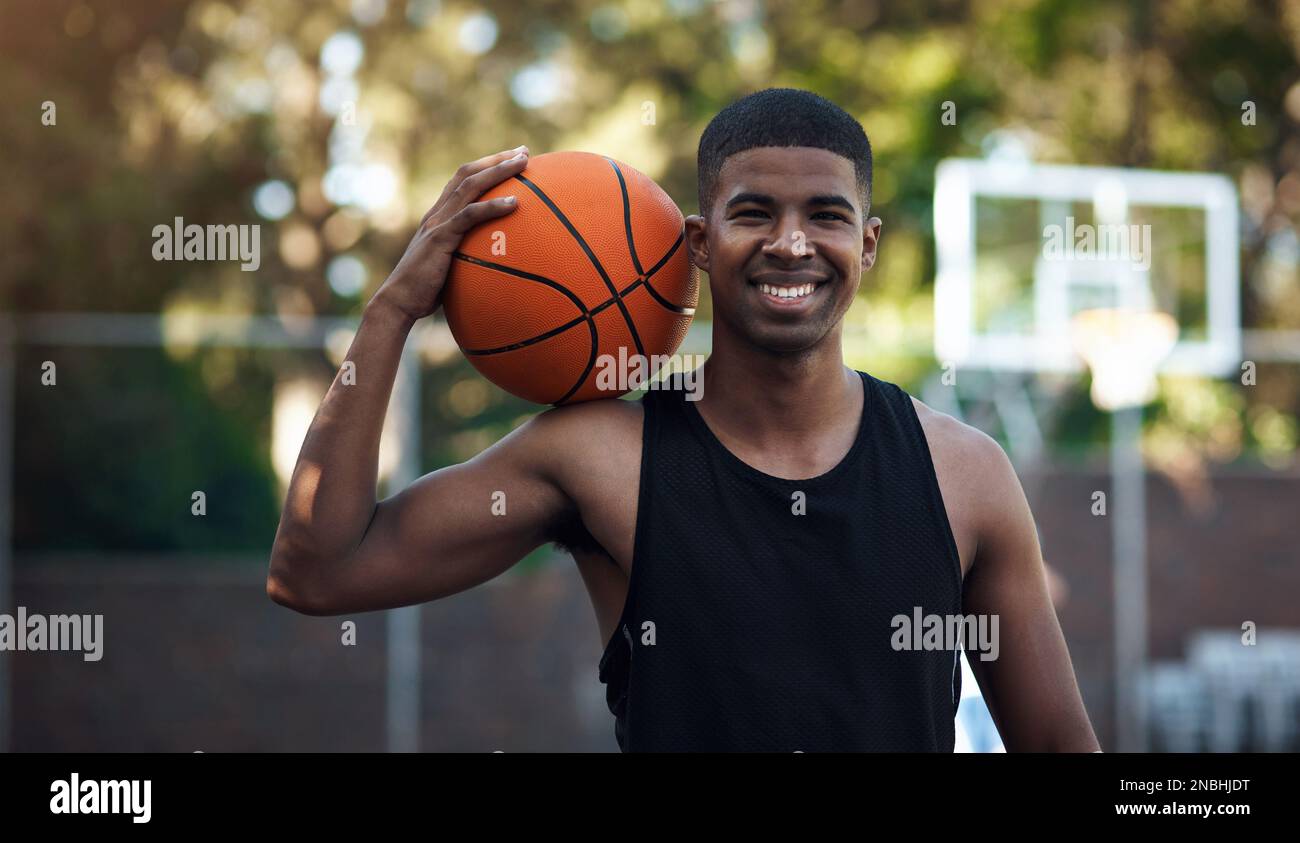 Lets go shoot some hoops. Portrait of a sporty young man standing on a ...