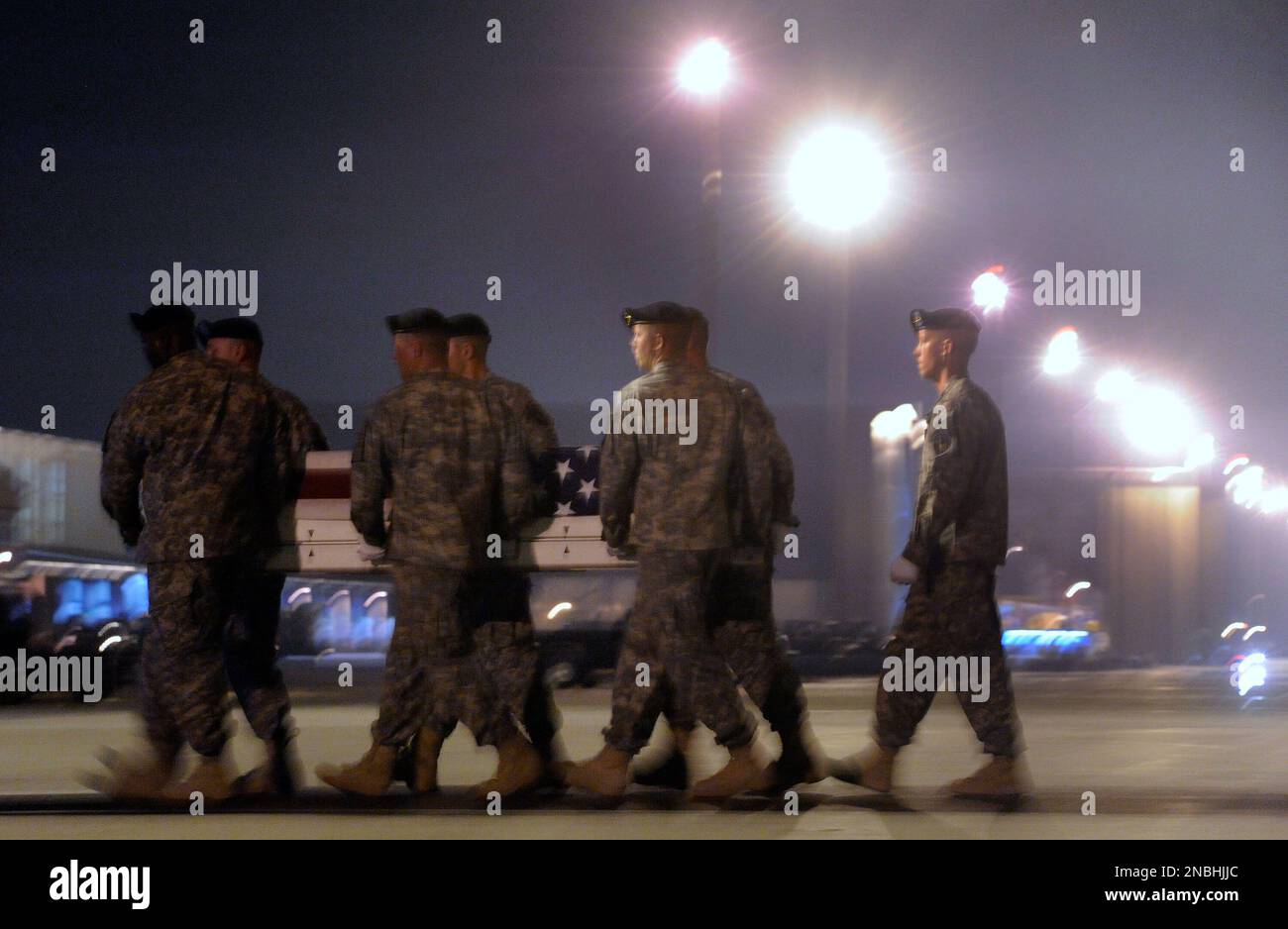 An Army carry team moves a transfer case containing the remains of Spc ...