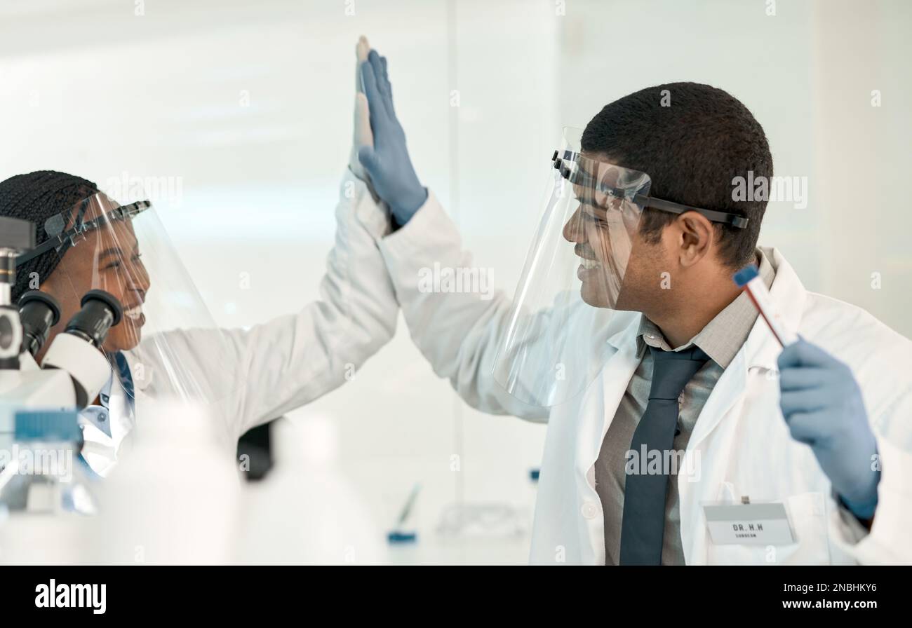 Case solved, case closed. two scientists giving each other a high five ... Case solved, case closed. two scientists giving each other a high five ...