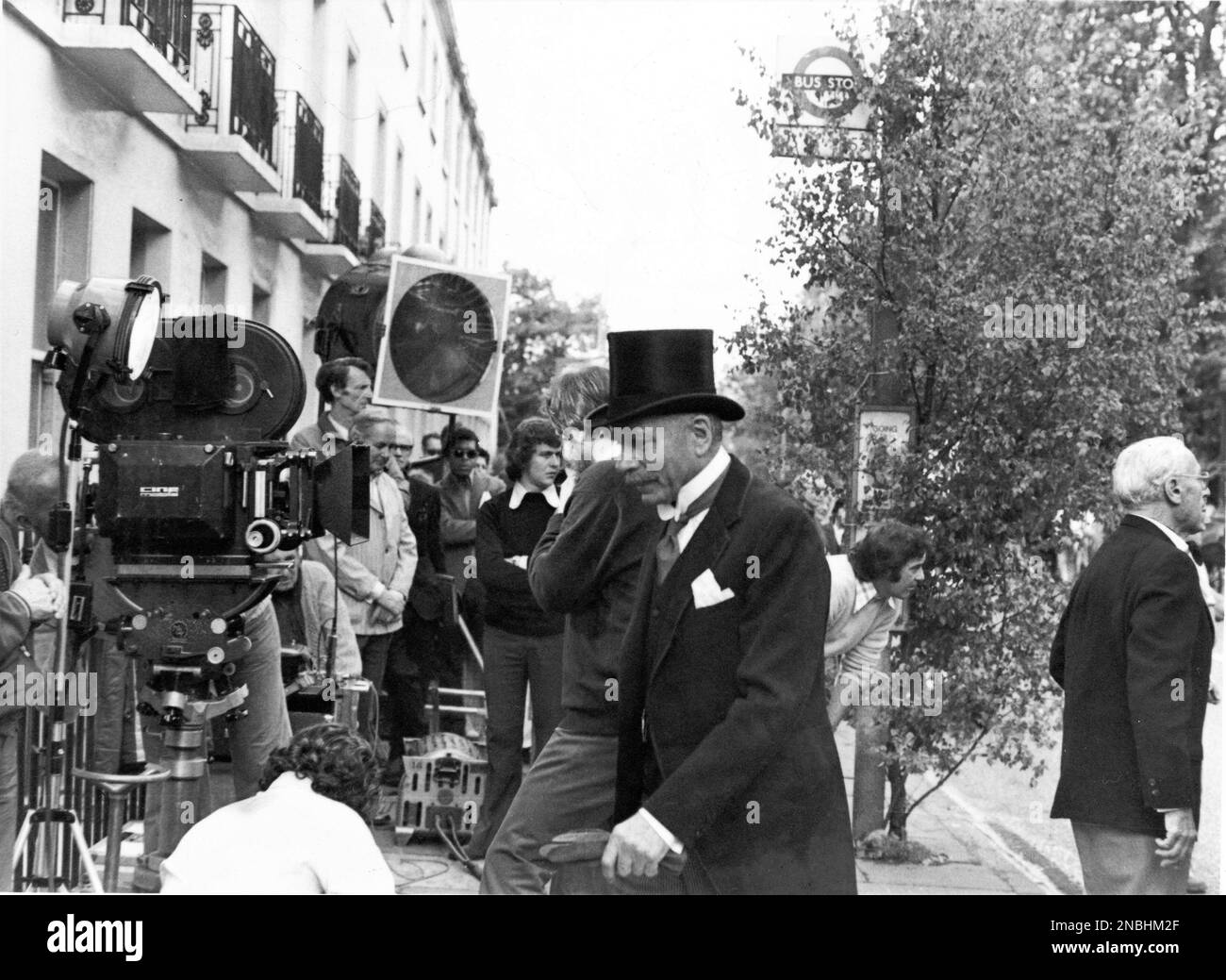 LAURENCE OLIVIER and Director GEORGE CUKOR (far right) on set location candid in London with ...