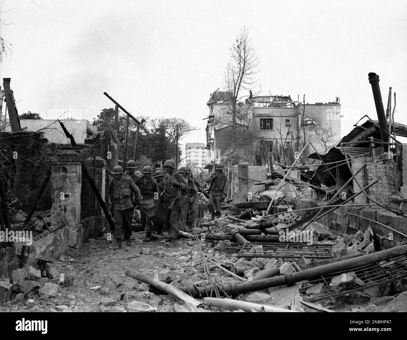 American soldiers of the 37th Division carry a dead soldier in a ...