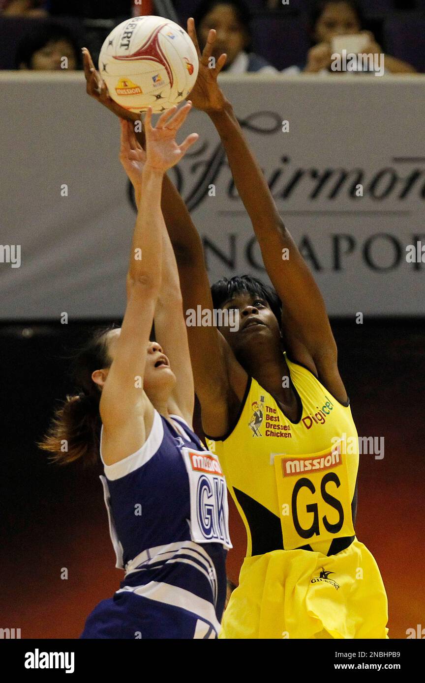 Singapore's Jean Ng, left, tries to block Jamaica's Romelda Aiken ...