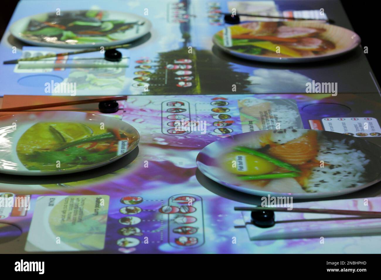 The interactive menu is projected onto the table and dishes are seen in ...