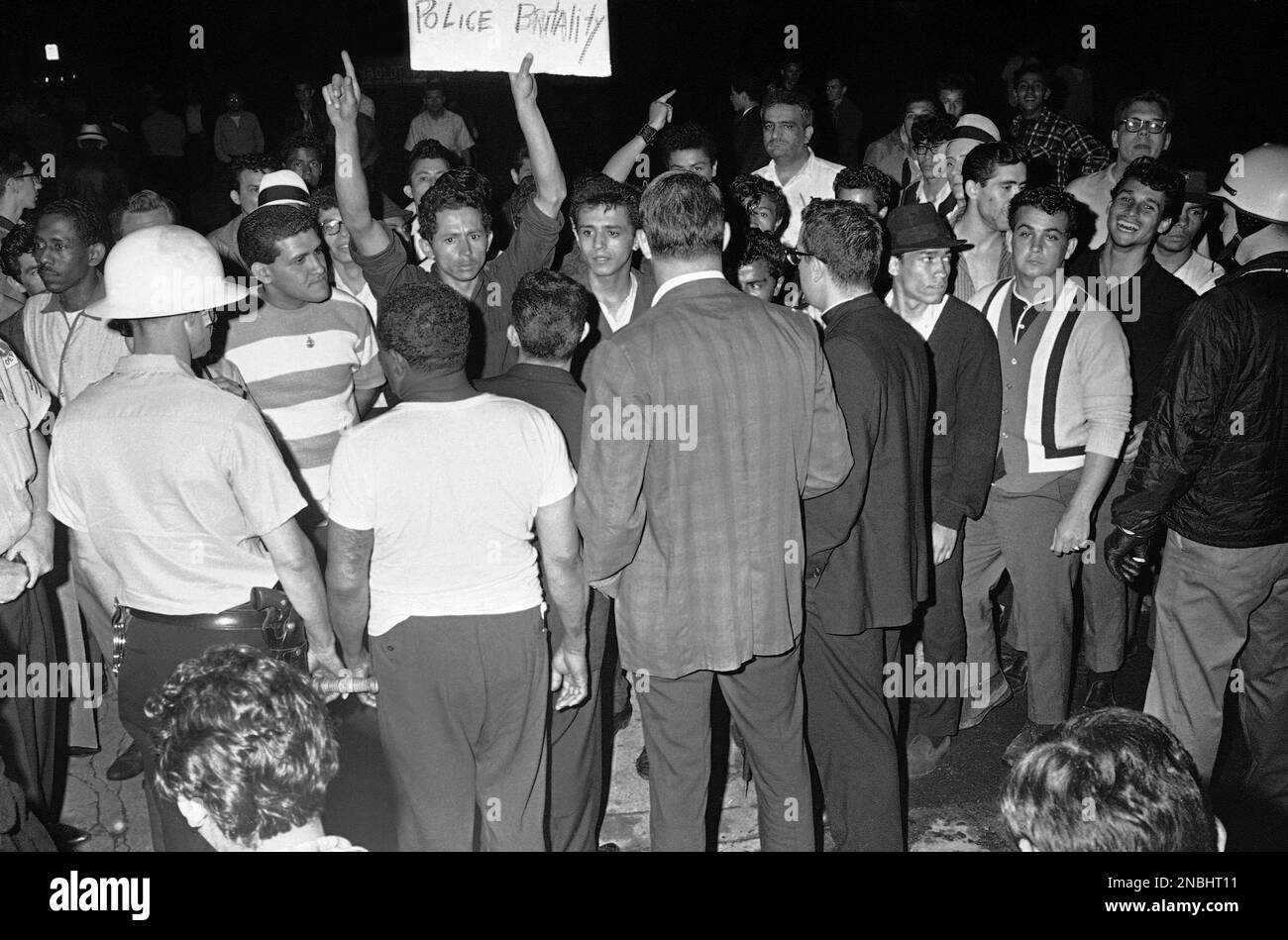 A clergyman and interpreter, right with backs to camera, try to ...