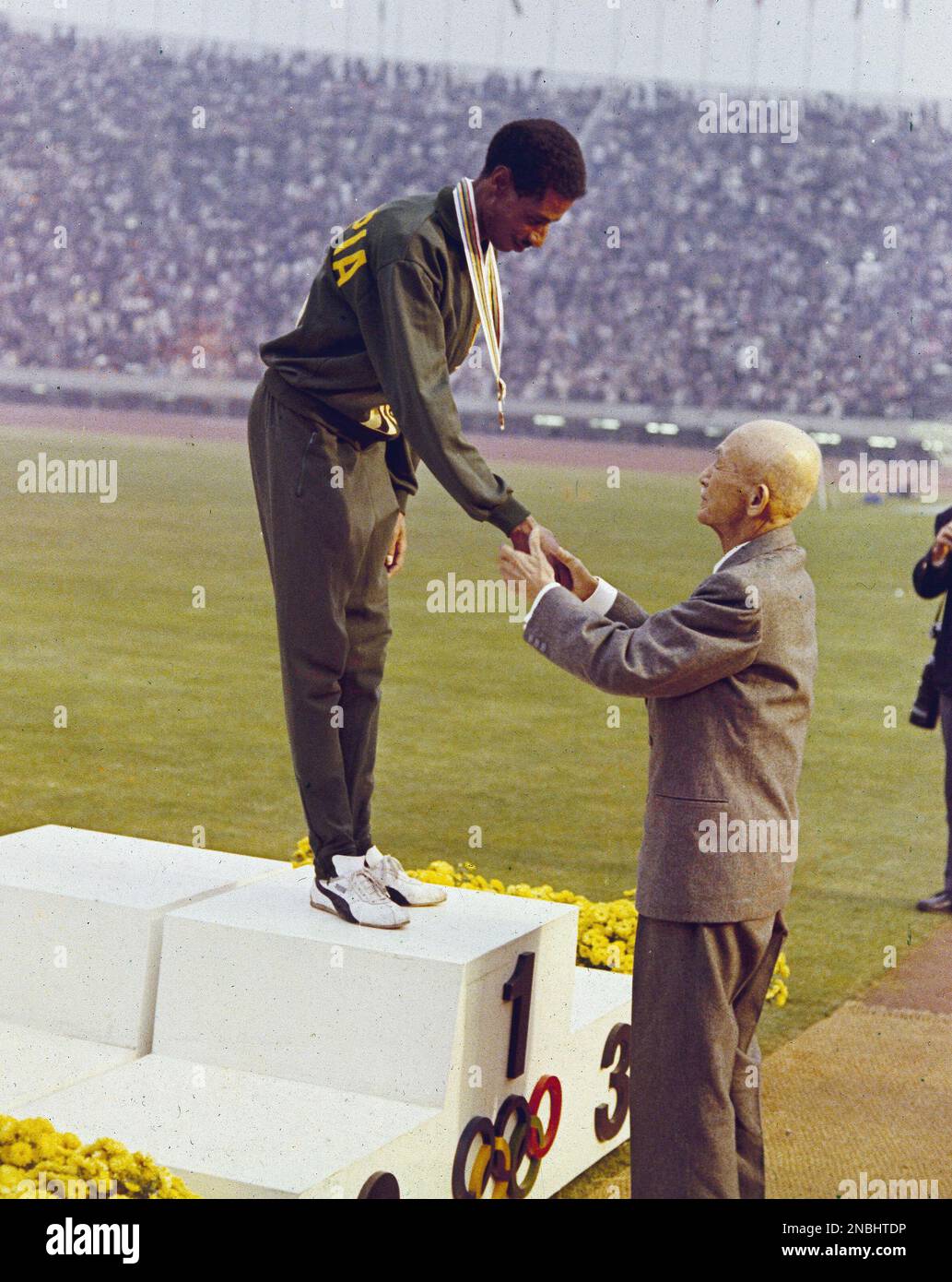 Abebe Bikila shown receiving the gold medal in Tokyo on Oct. 21, 1964. He is from Ethiopia. (AP ...
