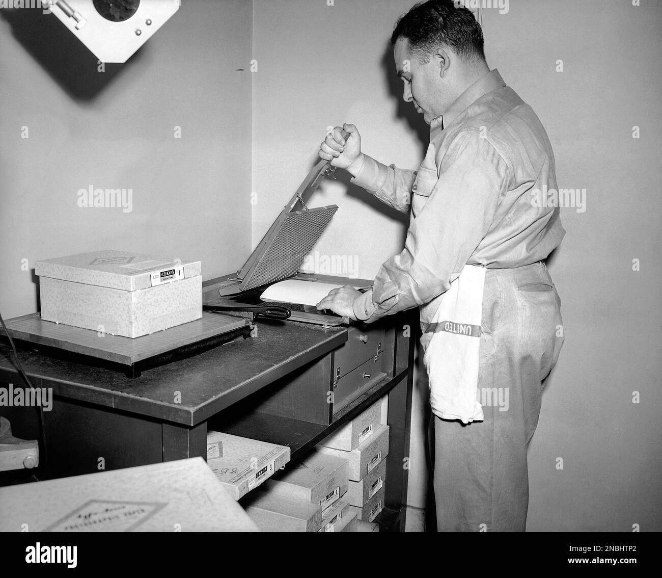 Pfc. Seymour Danchig of New York, works at contact printer in Signal ...