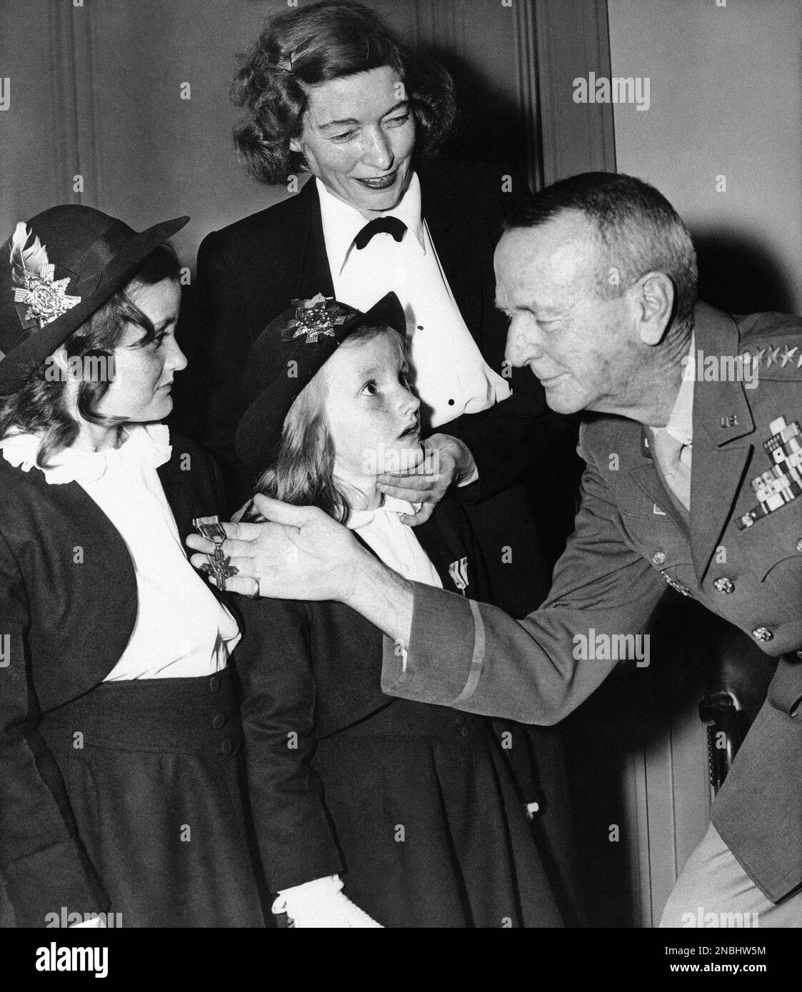 Diana Seater,8, left, receives from Gen. Jonathan M. Wainwright the ...