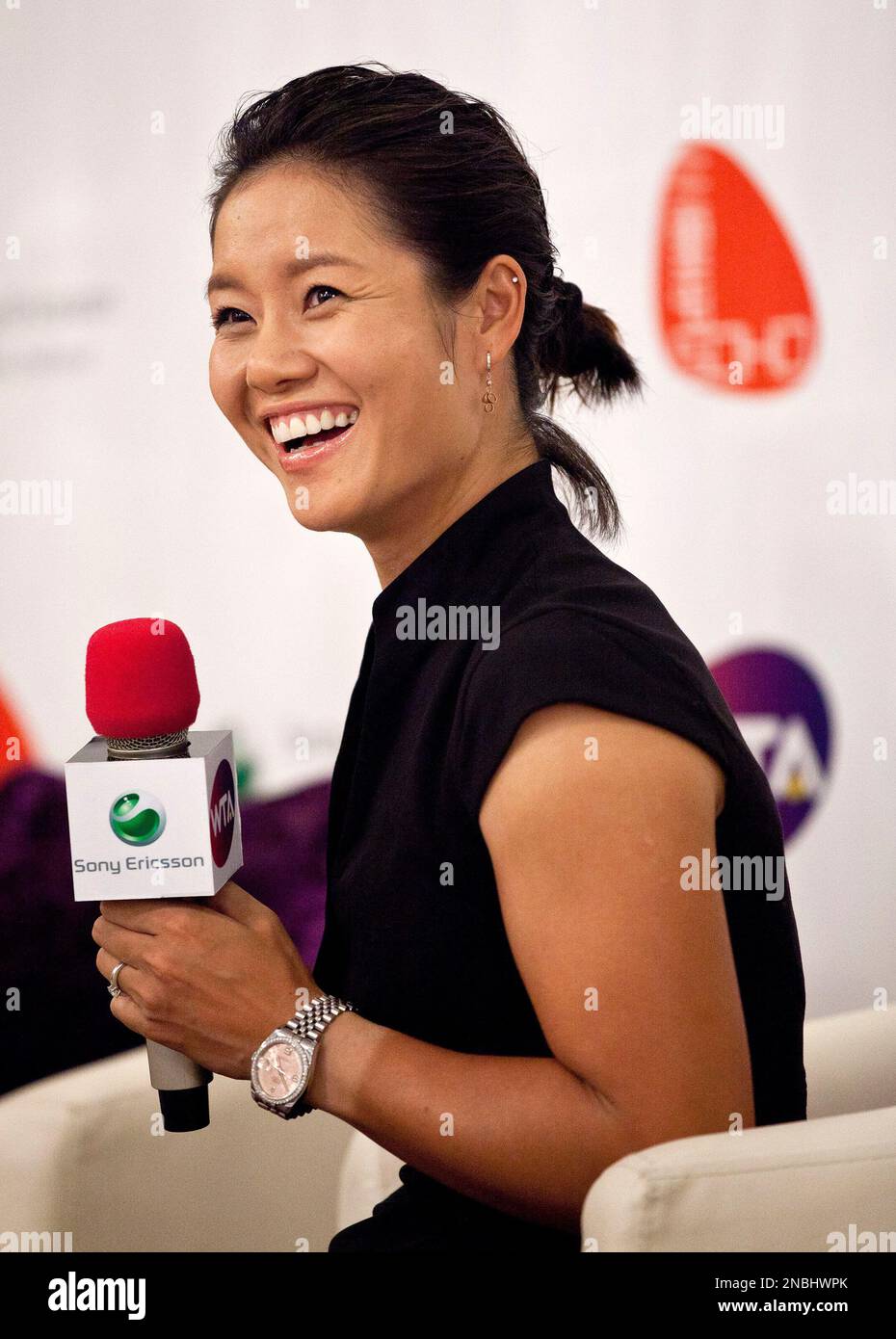 Chinese tennis player Li Na smiles as she speaks during a news ...