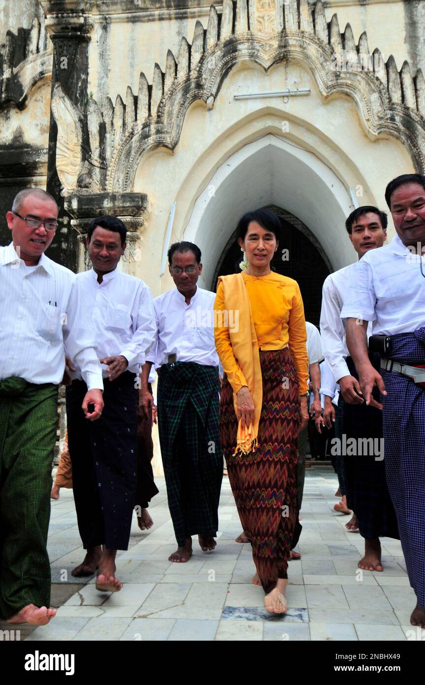 Myanmar democracy icon Aung San Suu Kyi, right, walks along with ...
