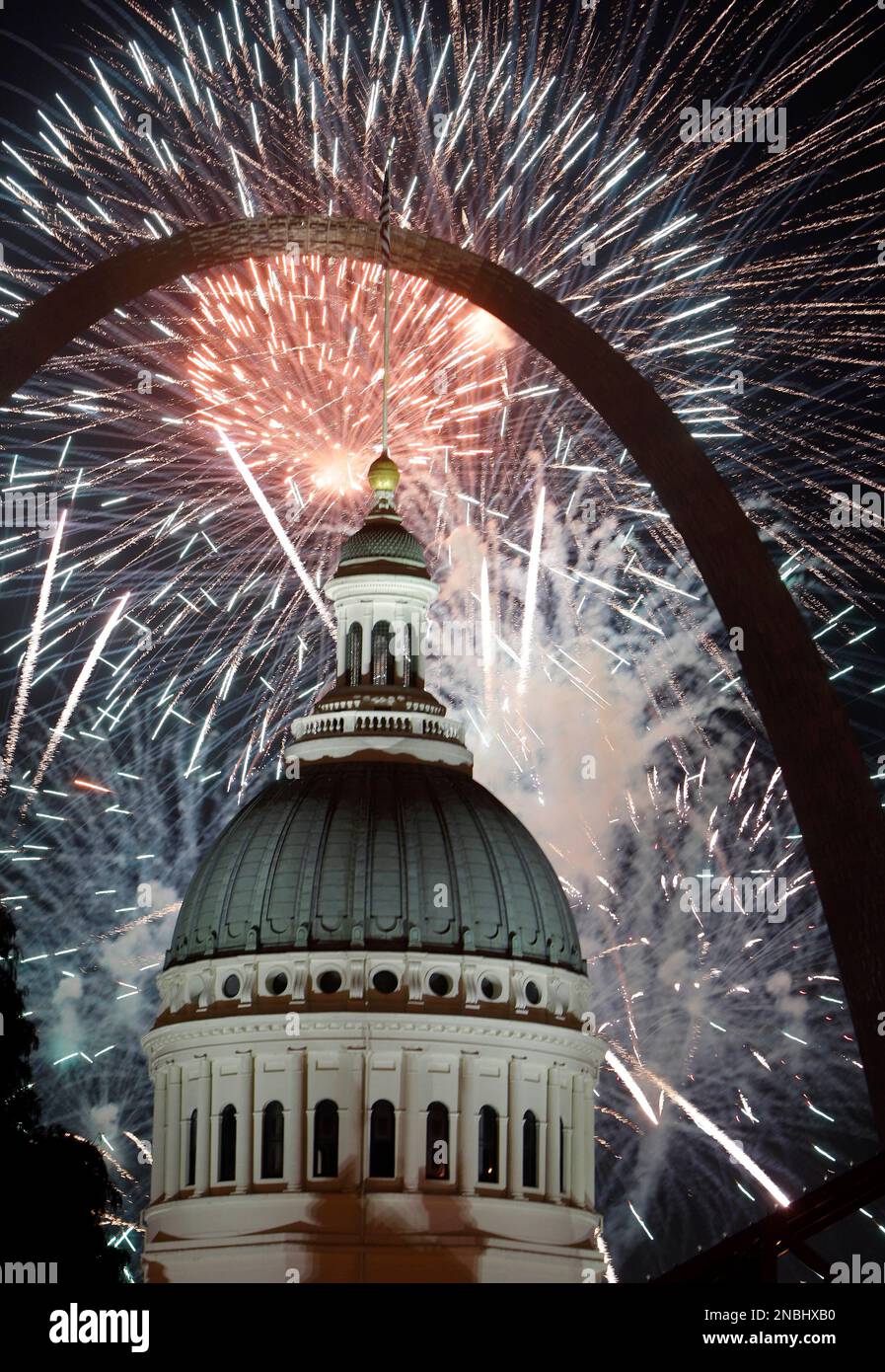 Fireworks light up the night sky behind the Gateway Arch and the Old ...