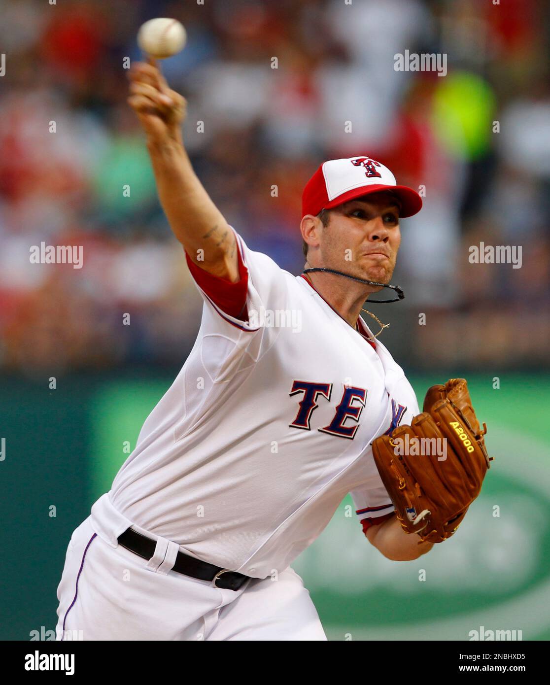 Texas Rangers starting pitcher Colby Lewis throws to the Baltimore ...