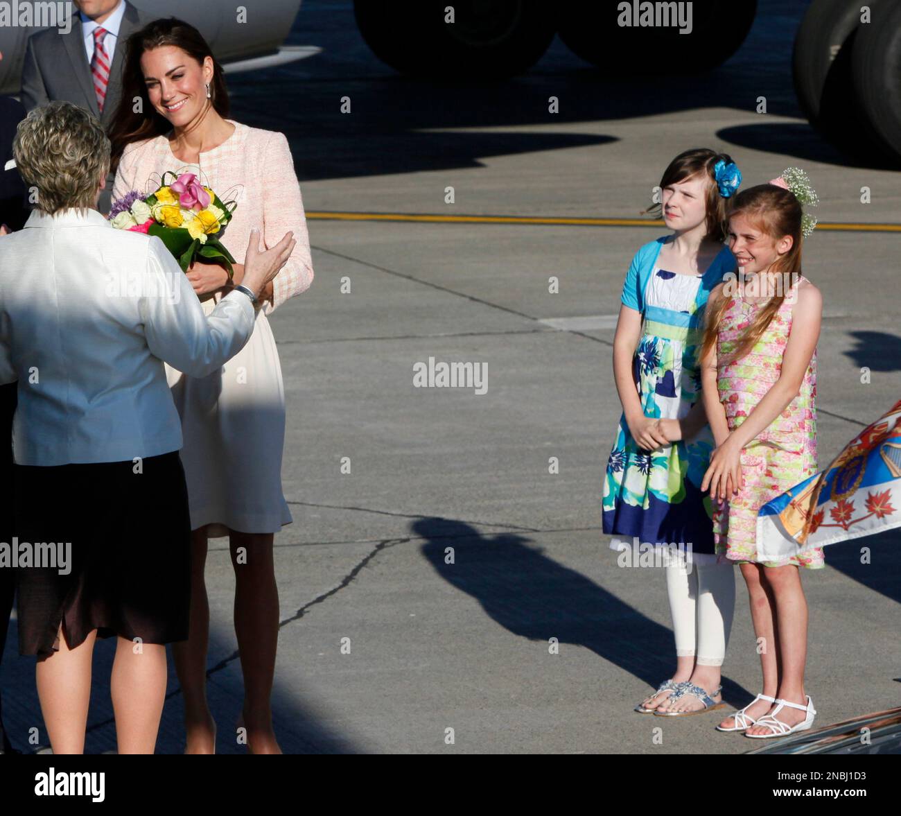 Kate, the Duchess of Cambridge, is greeted while two girls stand in ...
