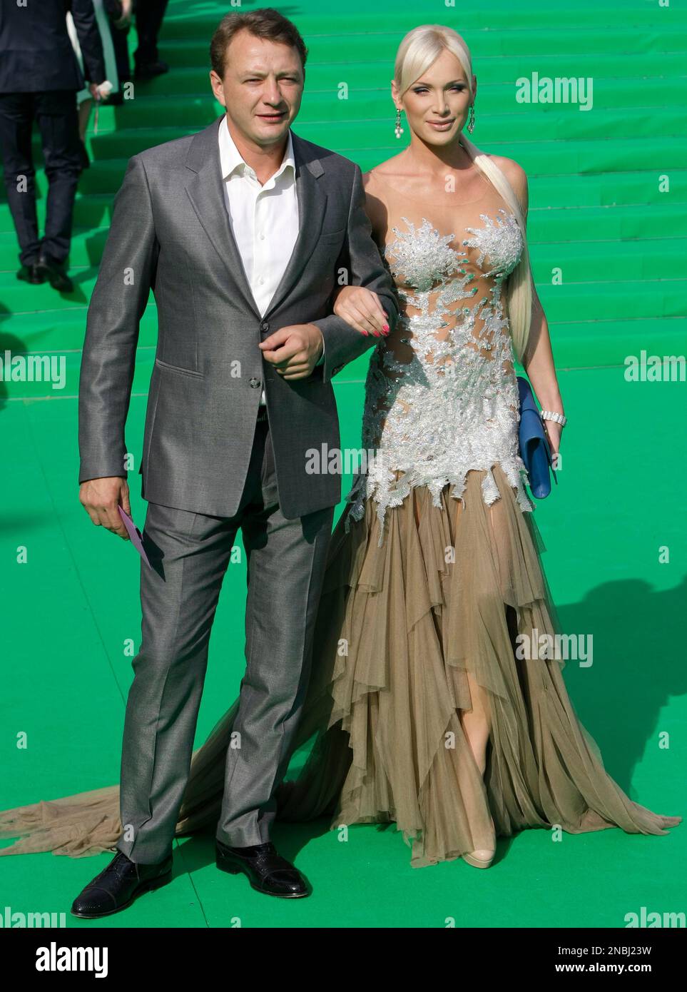 Russian actor Marat Basharov, left, with his girlfriend poses at the closing ceremony of the ...