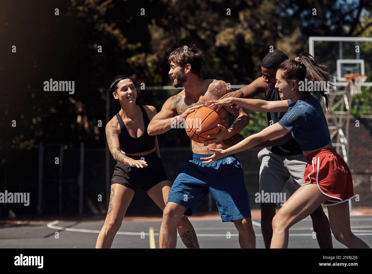Learning skills in passing, dribbling, shooting and defence. a group of ...