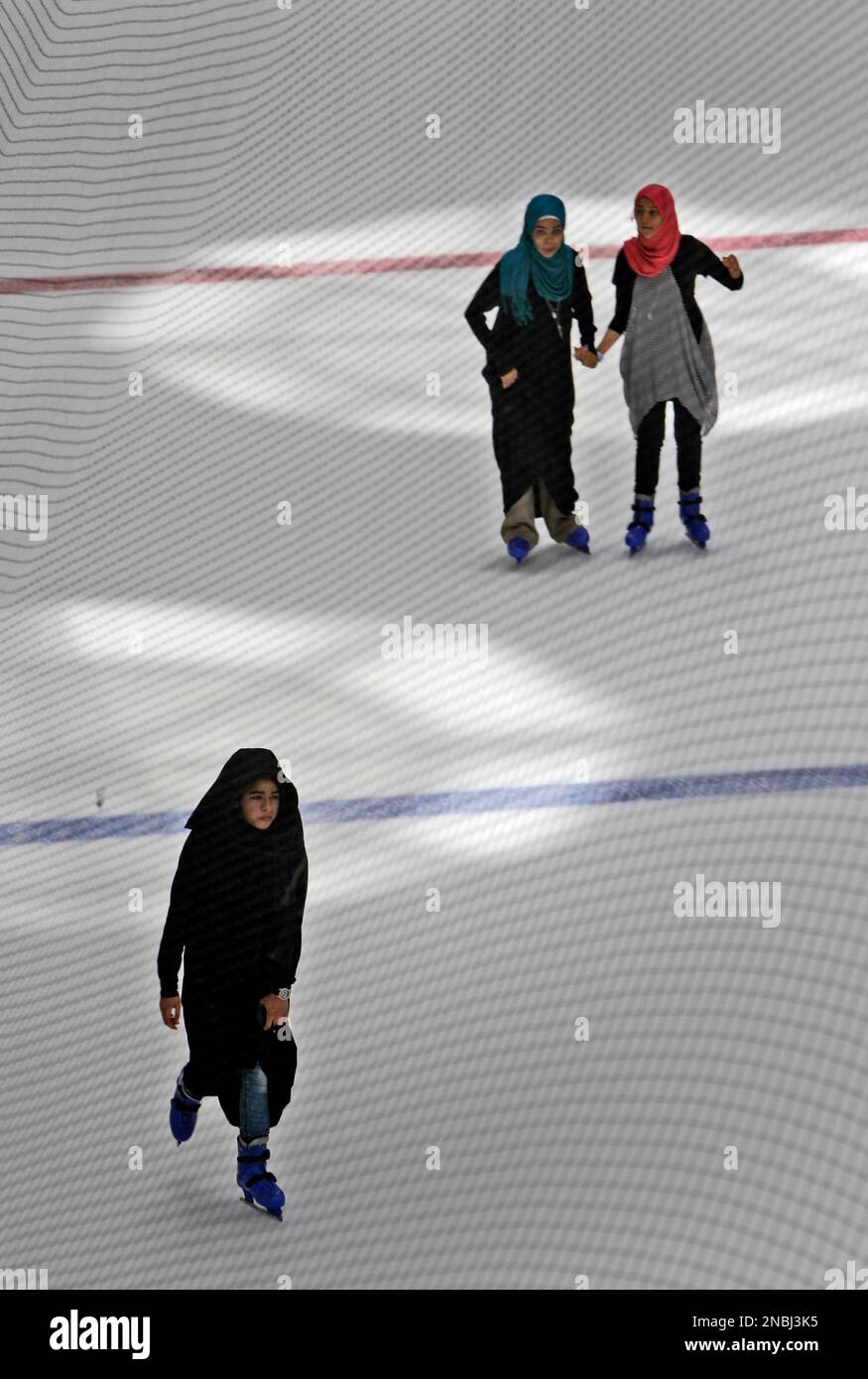 Arab teenagers of different nationalities slide on Dubai Ice Rink at a ...