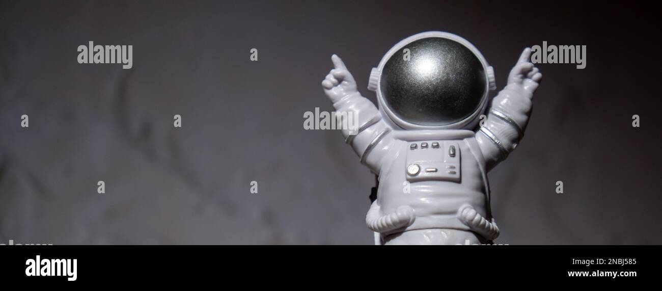 Plastic toy figure astronaut on moon concrete background Copy space ...