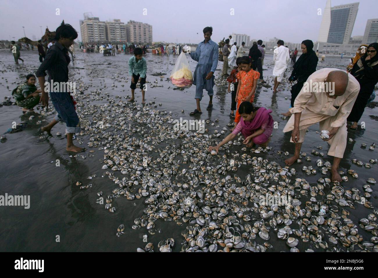 Pakistanis gather on the beach area of Karachi, Pakistan, several seen ...