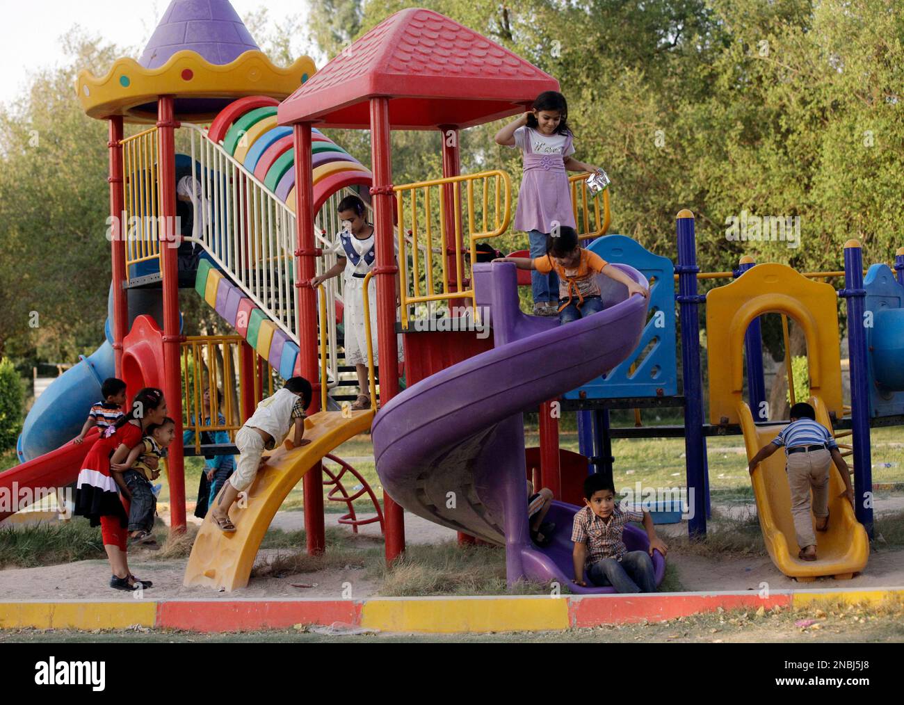 Children play at a park in central Baghdad, Iraq, Saturday, July 2 ...