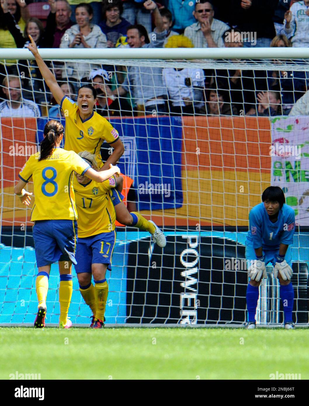 Sweden's Lisa Dahlkvist is celebrated by teammates Lotta Schelin , left ...