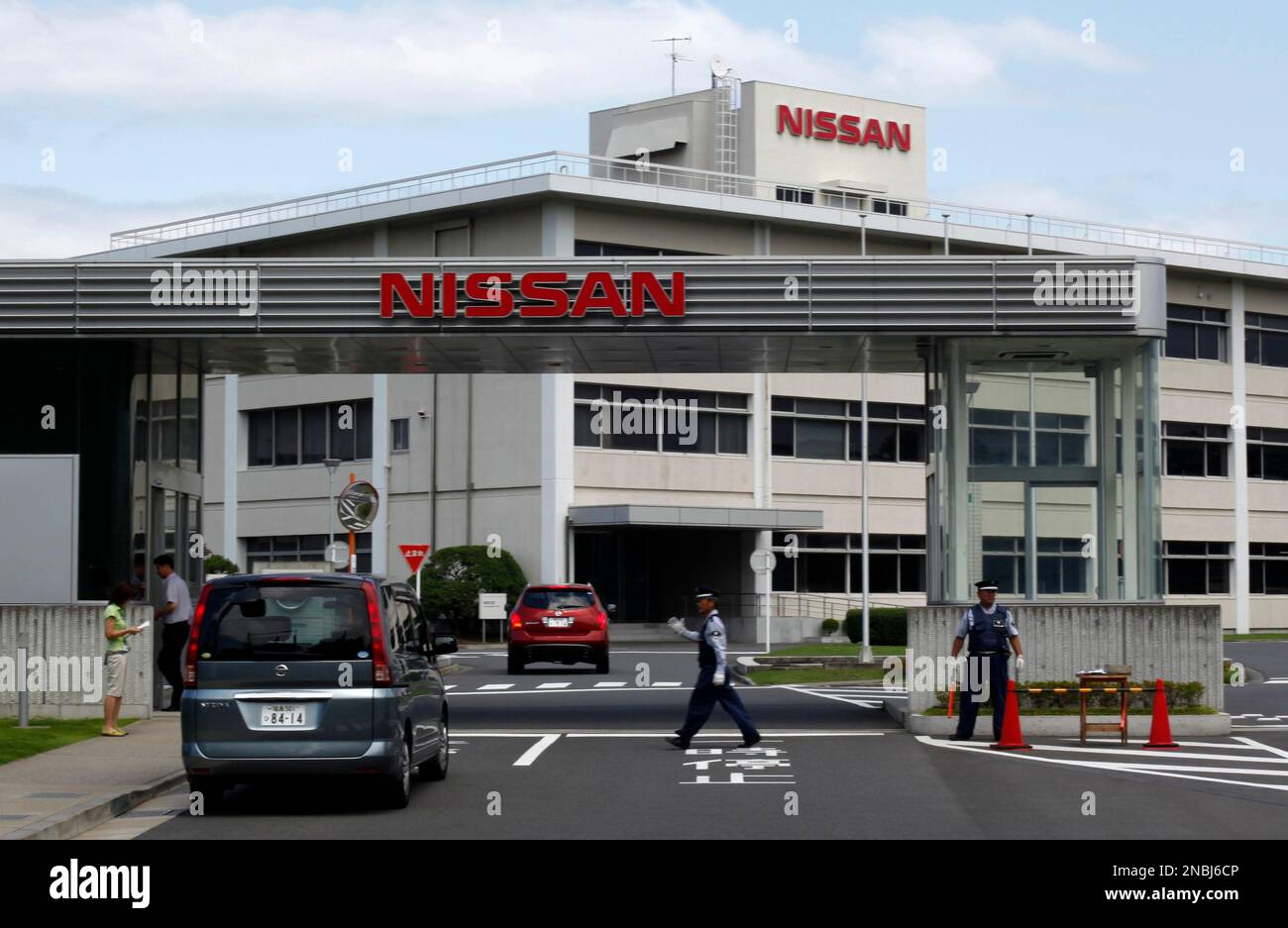 Guards stand at the entrance of Nissan Motor Co's Oppama plant in ...