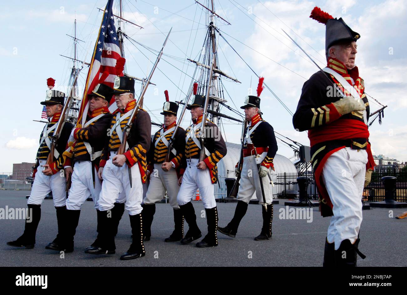 Reenactors in 1812 Marine Guard uniforms march in front of the USS ...
