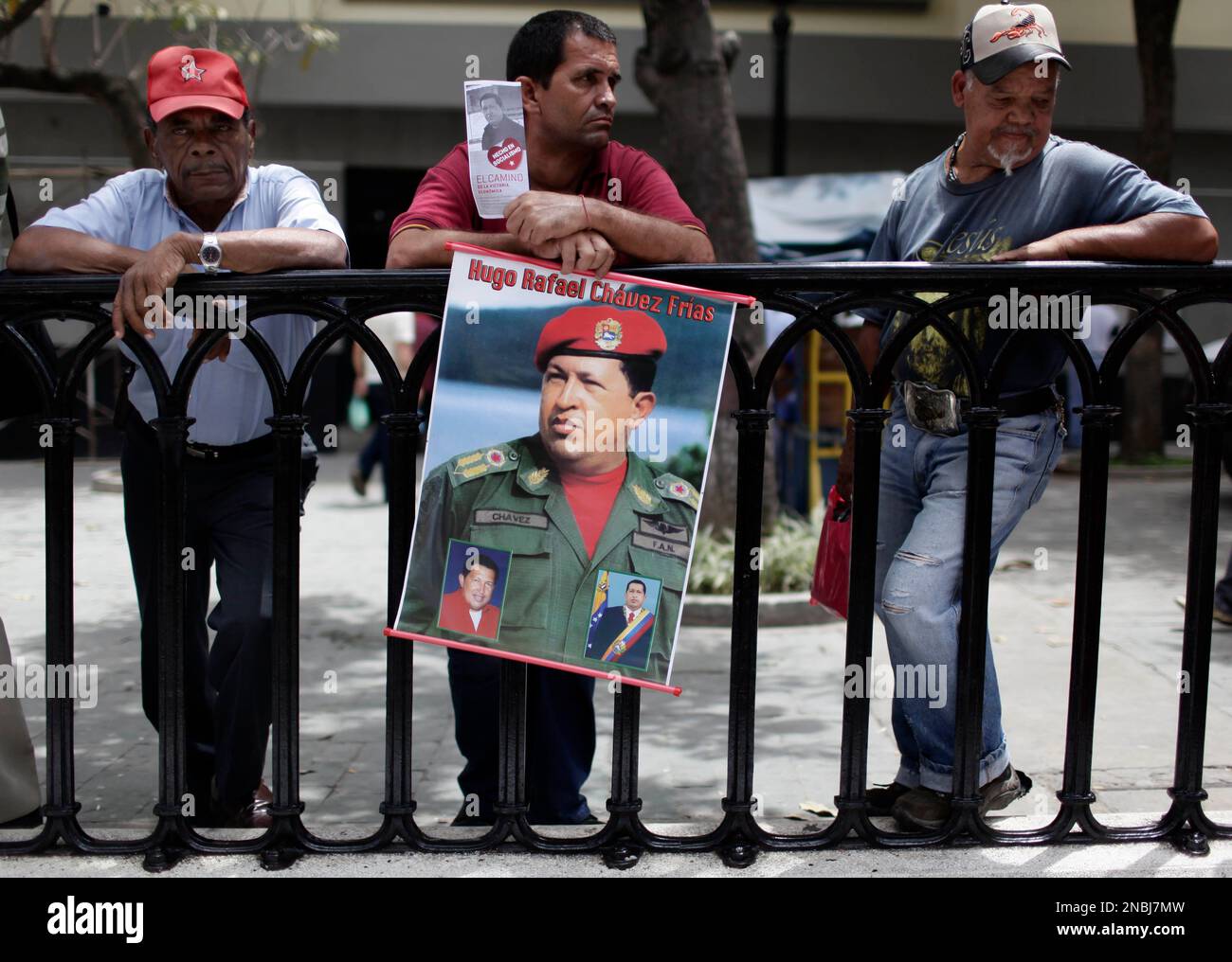A supporter of Venezuela's President Hugo Chavez holds a sign depicting ...