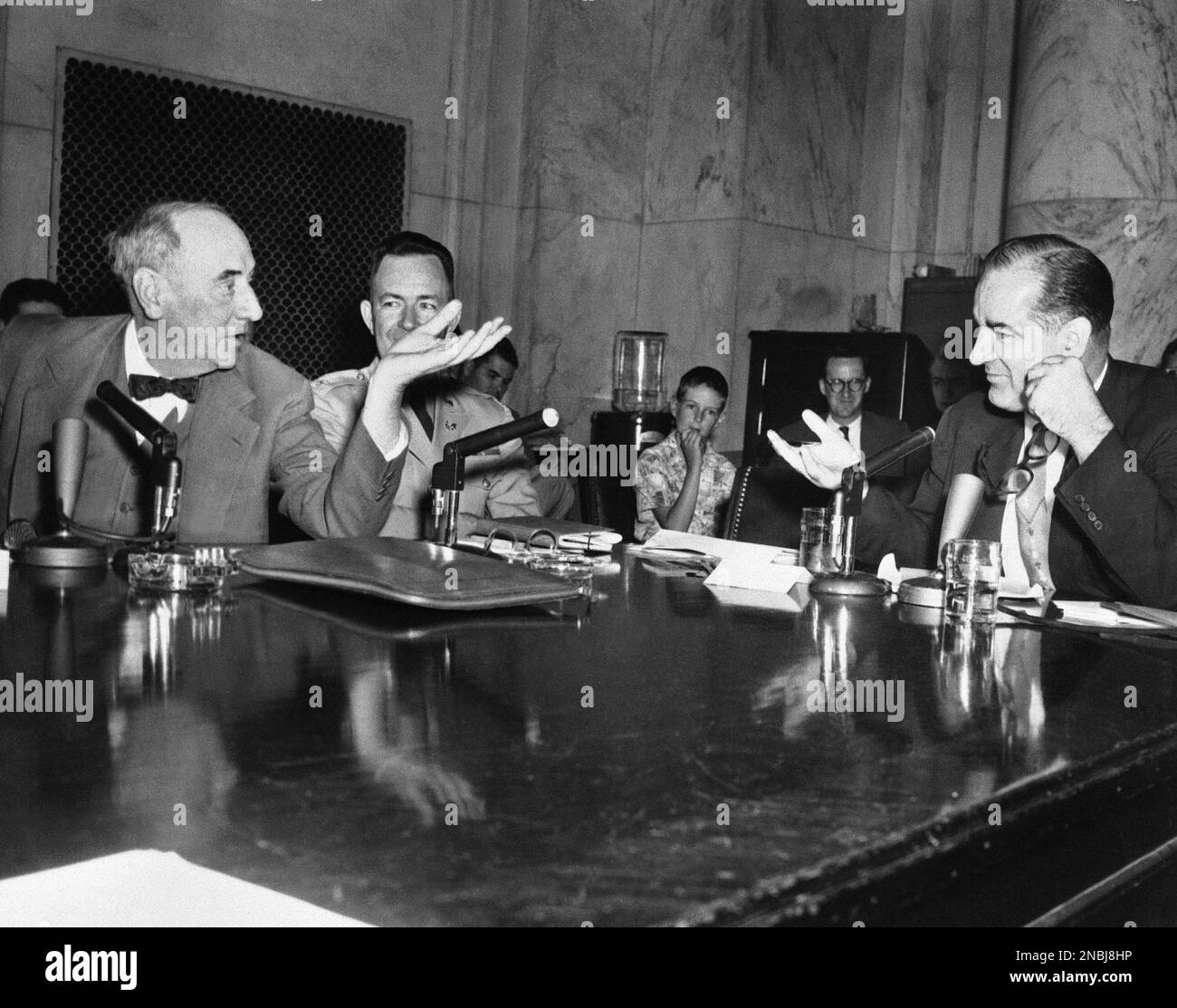 Sitting side by side communication microphone authority Black and White ...