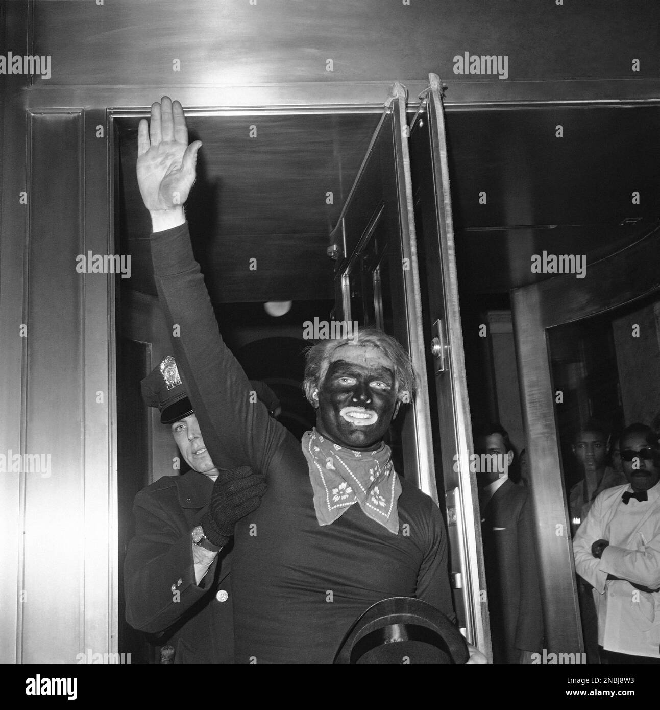 A man made-up in blackface is bustled off the floor of the House of ...