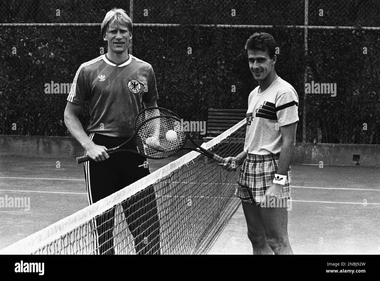 West German players Pierre Littbarski, right, and Uwe Rahn, left ...