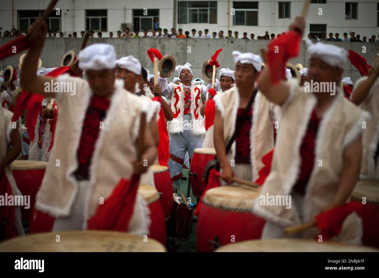 Drum dance performers play during a government organized celebration ...