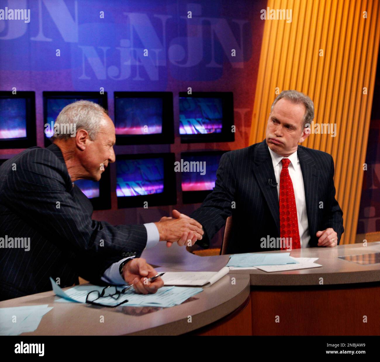 News anchors Michael Aron and Jim Hooker greet as they finish the final ...