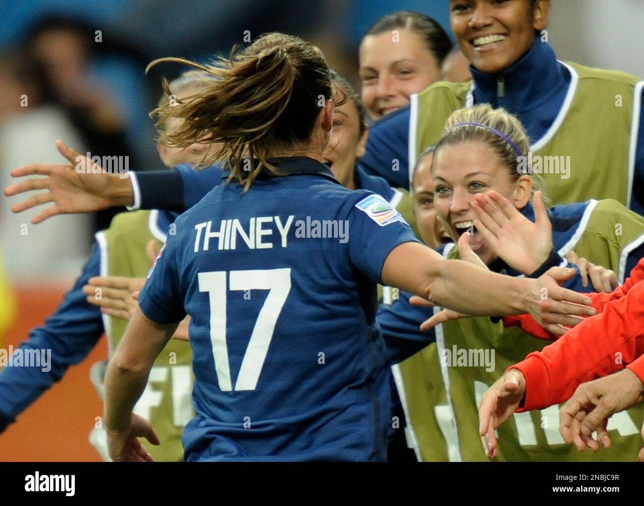 France's Gaetane Thiney, 17, is congratuled by teammates after scoring ...