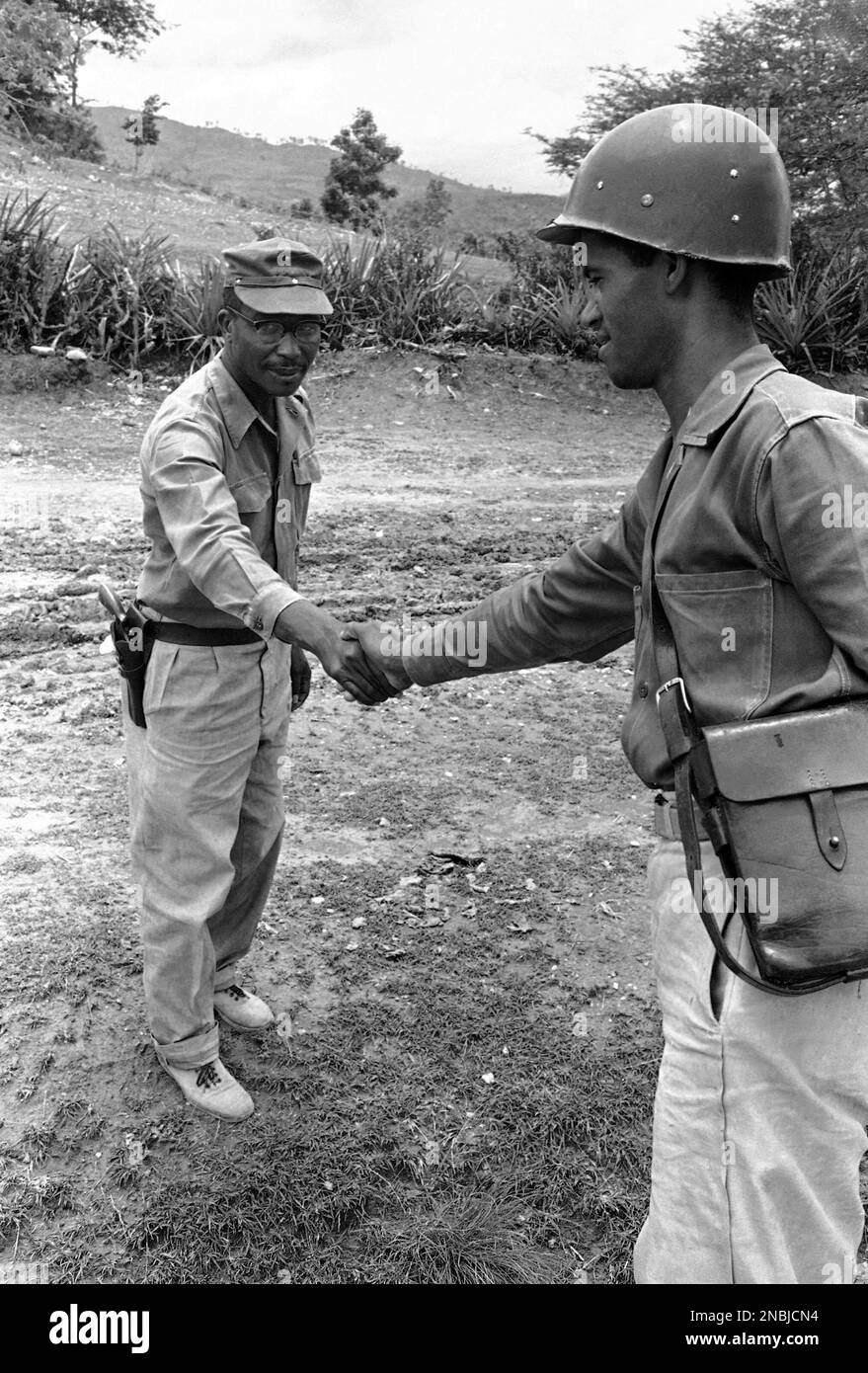 Haitian and helmeted Dominican soldiers shake hands near Elias Pina ...