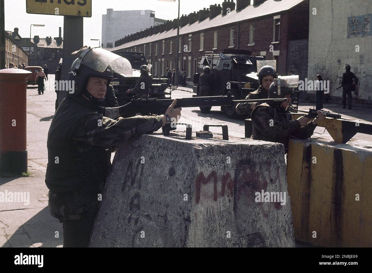 British Army soldiers man a road block during disorders in the Falls ...