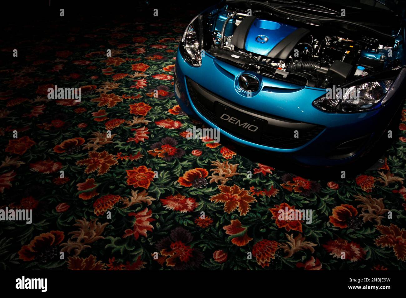 The engine room of a new Mazda Demio is shown during a press conference ...