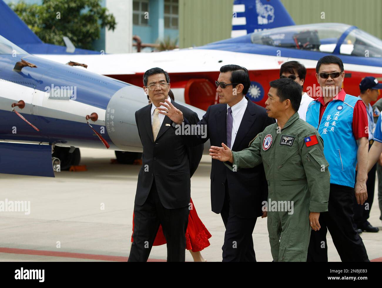 Taiwan's President Ma Ying-jeou, in sun glasses, views various versions ...