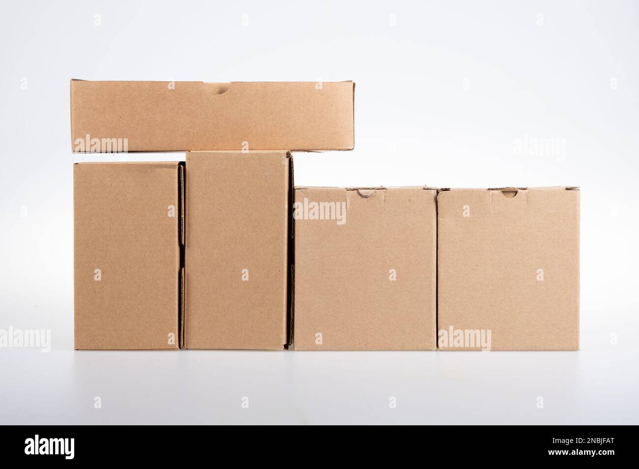 Stack of brown line cardboard boxes on white background Stock Photo - Alamy