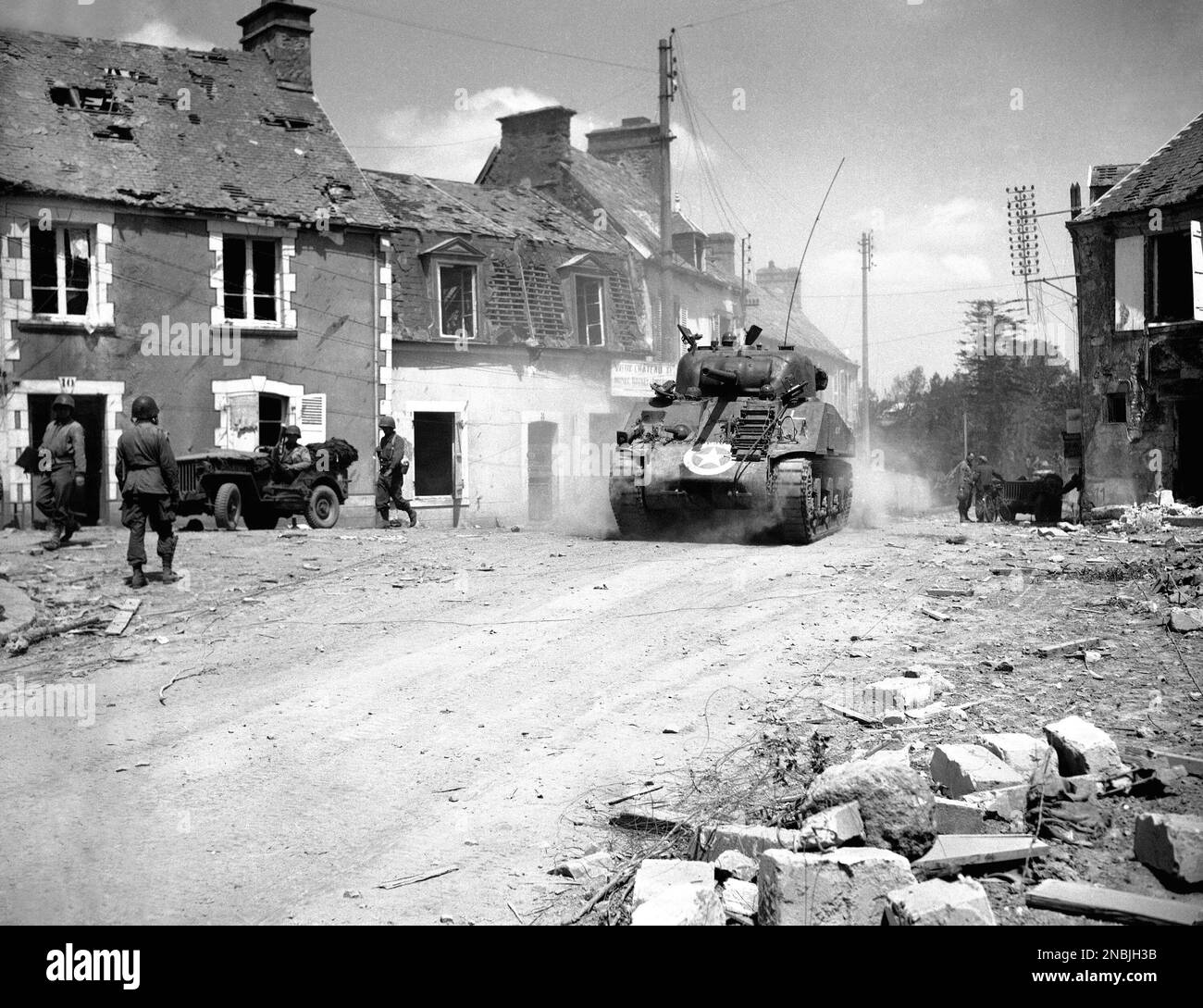 A street scene in St. Sauveur on June 19, 1944 as tanks and armored ...