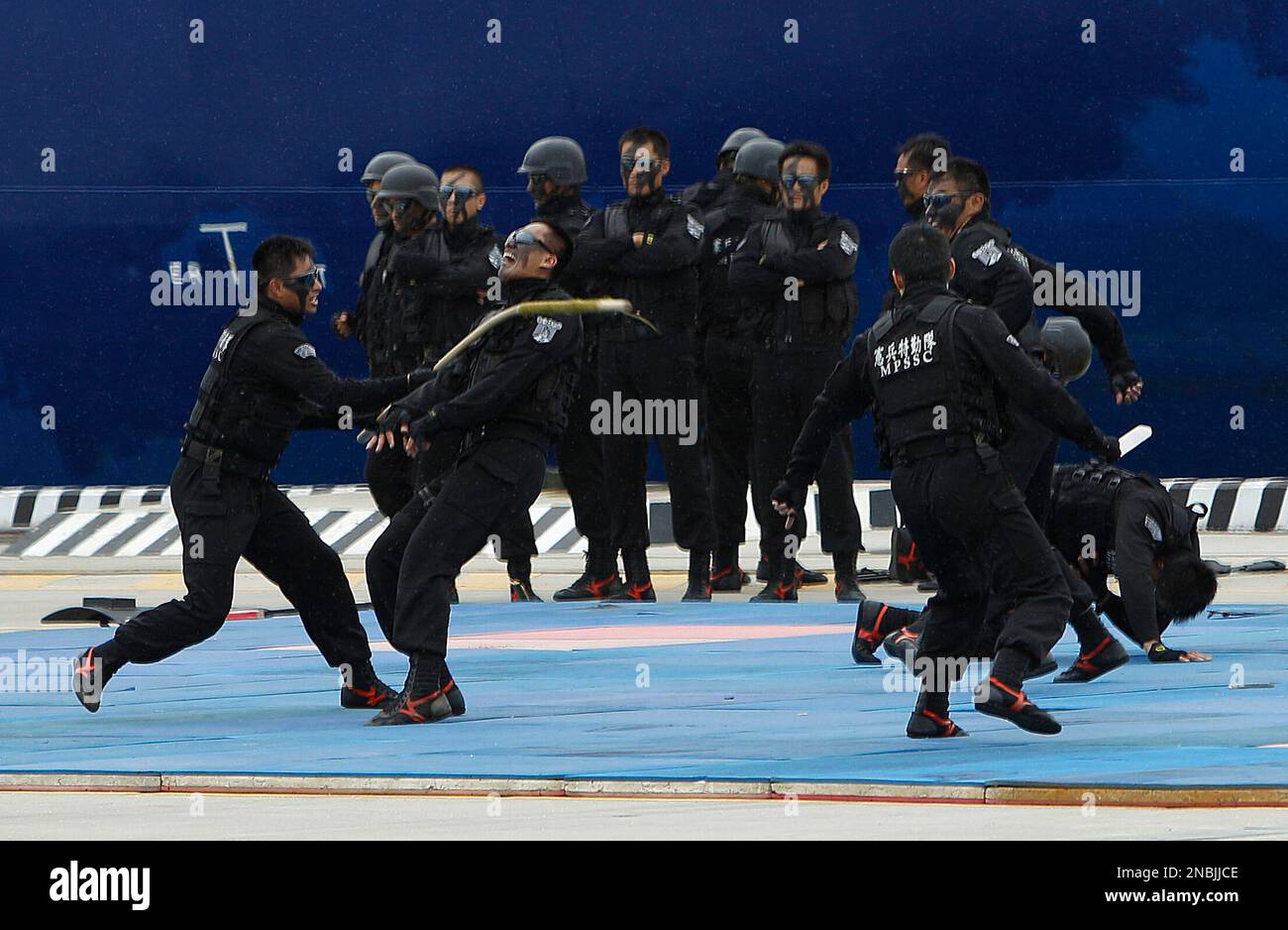 Police strike force teams demonstrate martial arts at the Taipei port ...