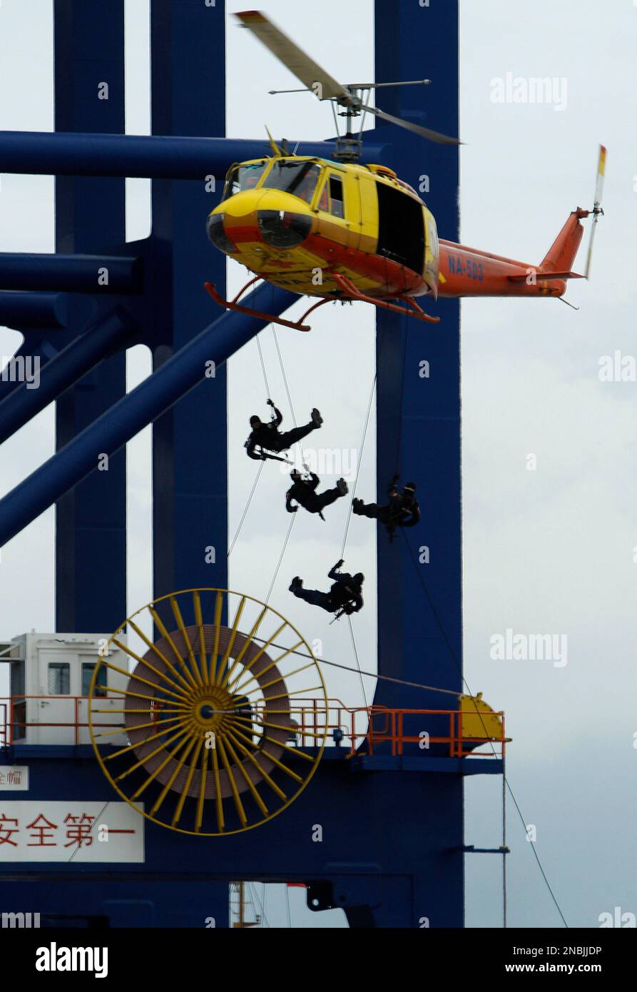 Police strike force teams rappel from a helicopter in a hostage ...