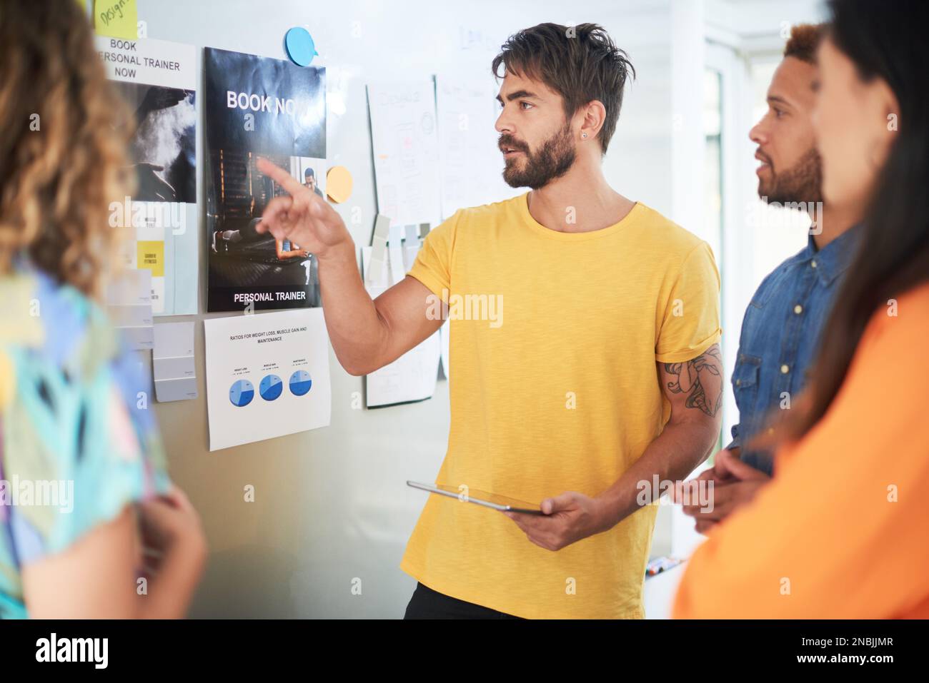 A plan any personal trainer would be proud of. a group of young businesspeople meeting to create ...