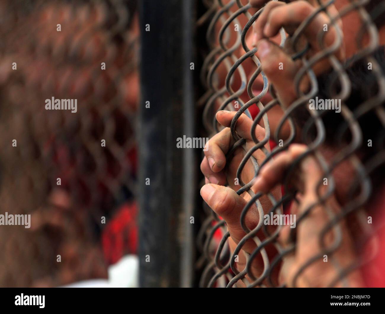 Inmates watch a “fulbito,” or Peruvian soccer tournament through a ...