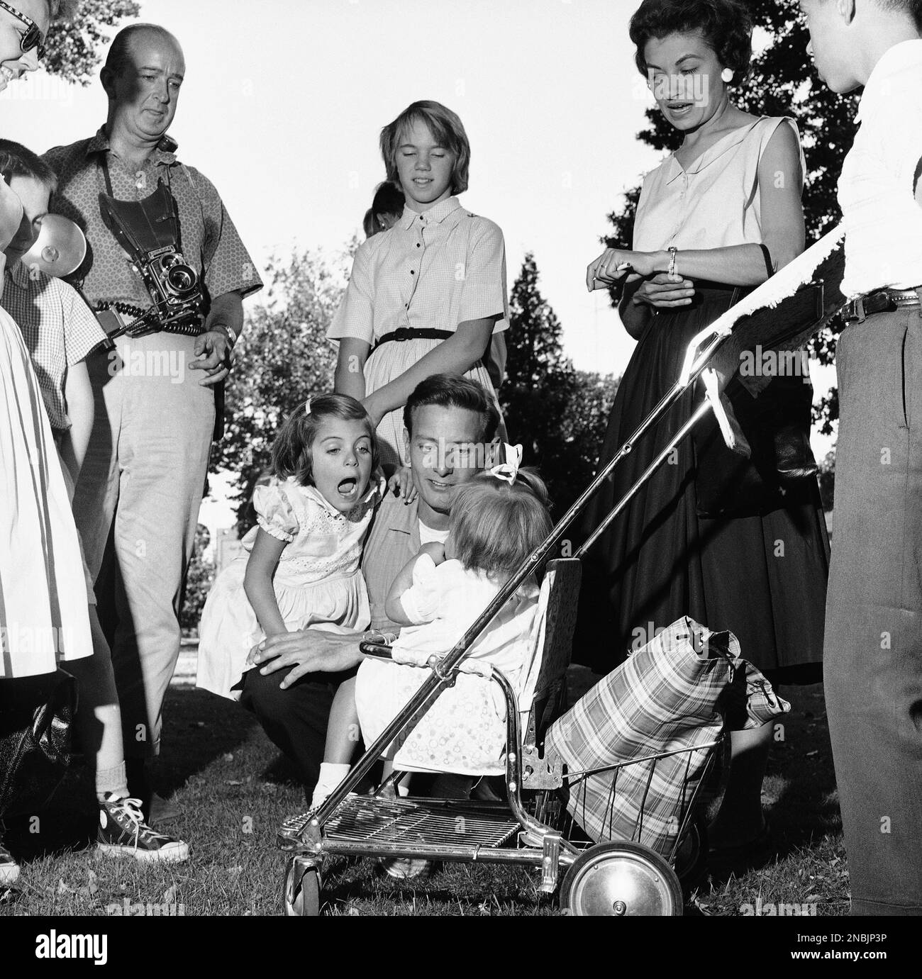 J. Robert Kennedy, kneeling, smiles at his youngest, Gayle, 11 months ...