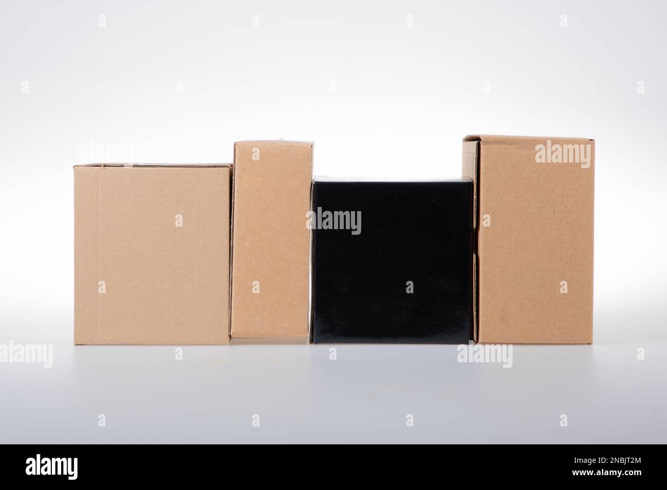 Stack of cardboard boxes black brown box of different sizes on white ...