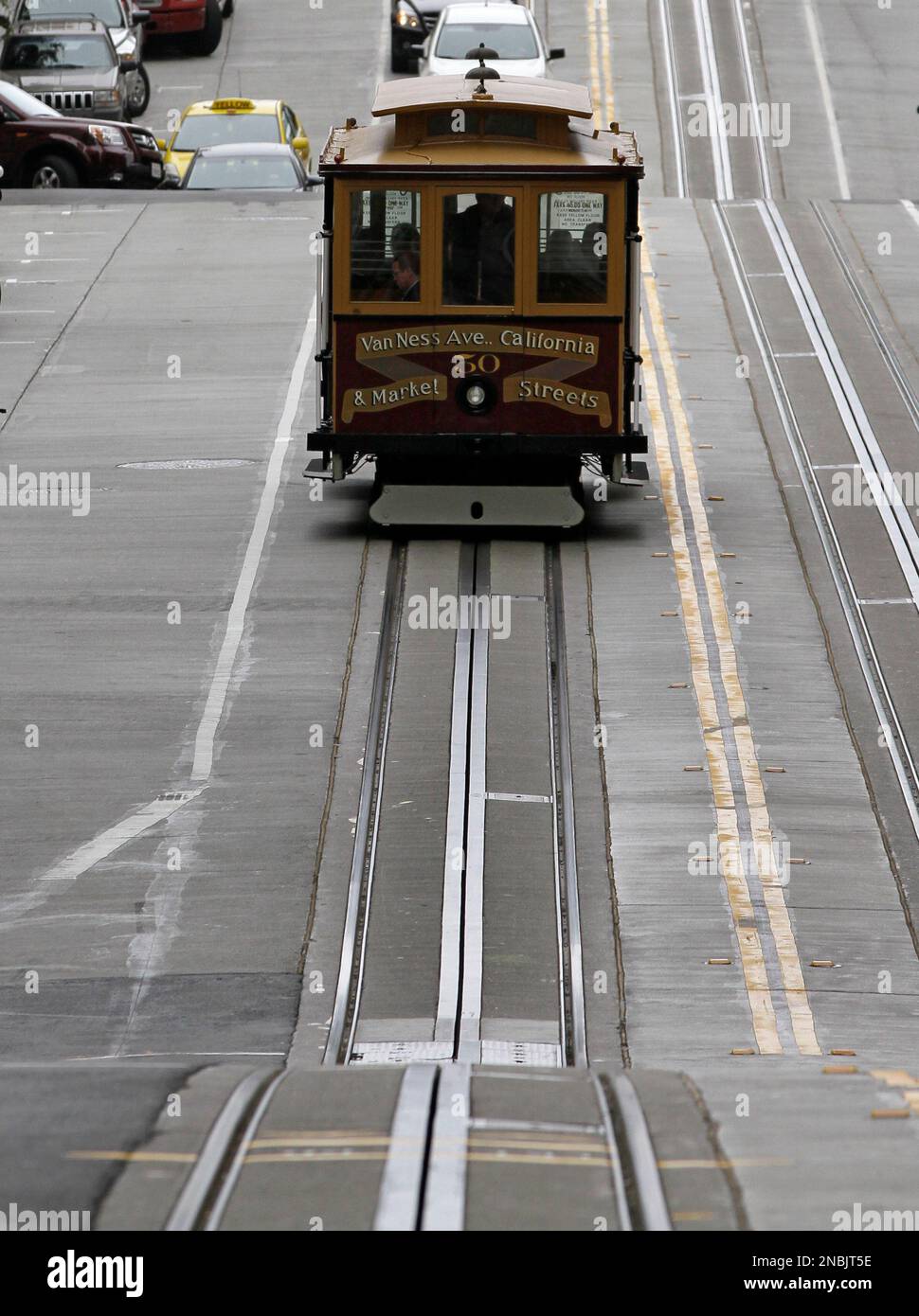 A cable car makes its way down California Street toward Market Street ...