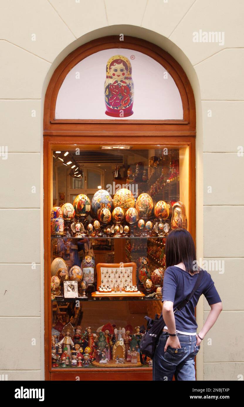 A tourists looks at a shop window of a store selling the typical ...