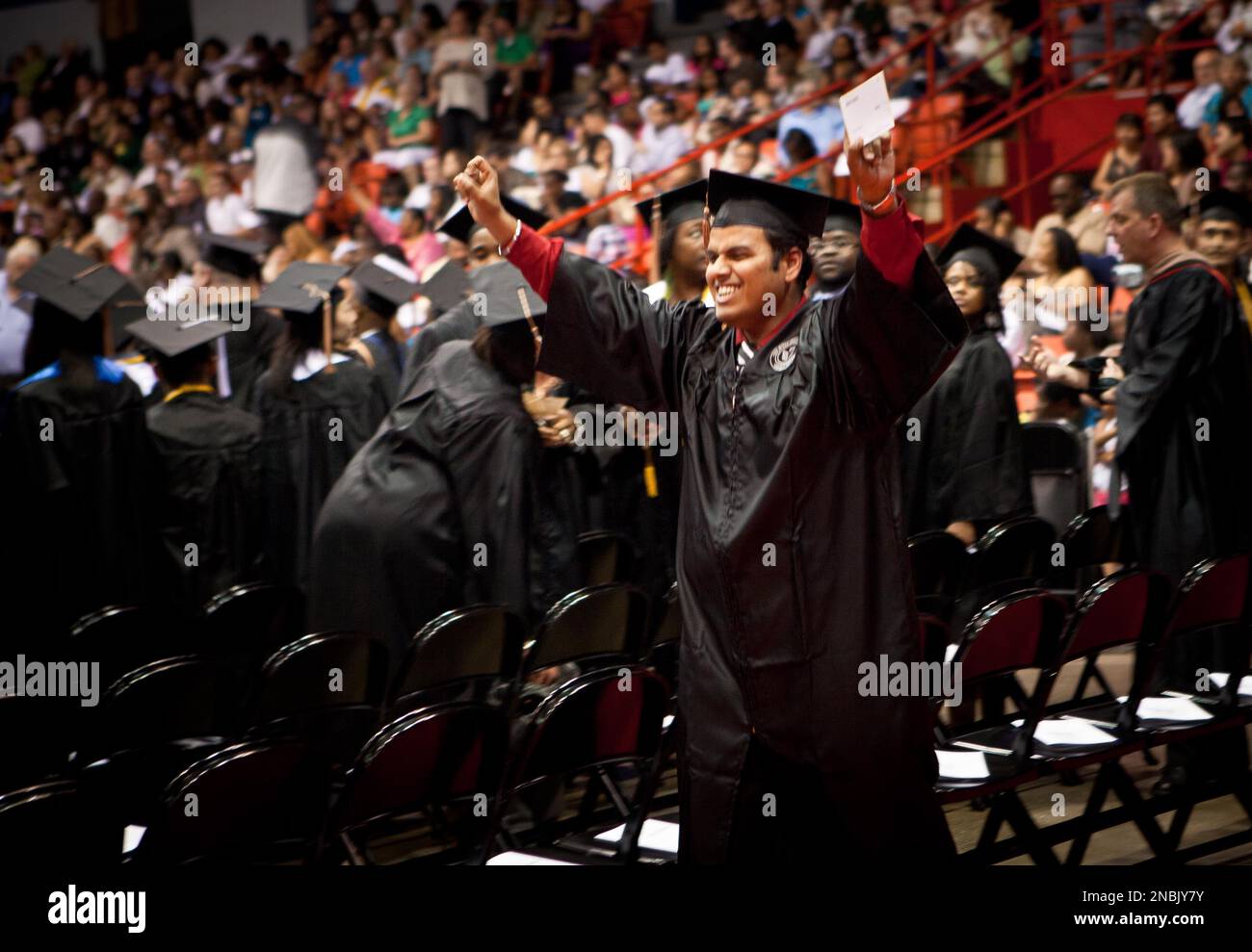 Nikhil Mullick cheers before getting his diploma at DeVry University's ...