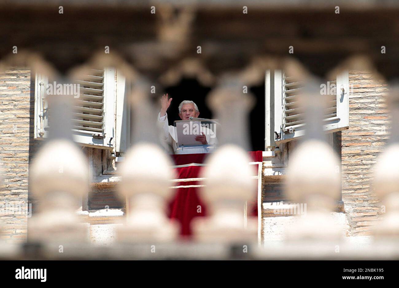 Pope Benedict XVI gestures to faithful as he delivers the Angelus ...