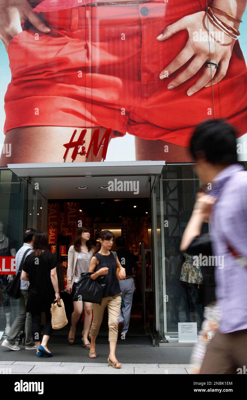 Shoppers hang out at a clothing store in Tokyo Sunday, June 26, 2011 ...