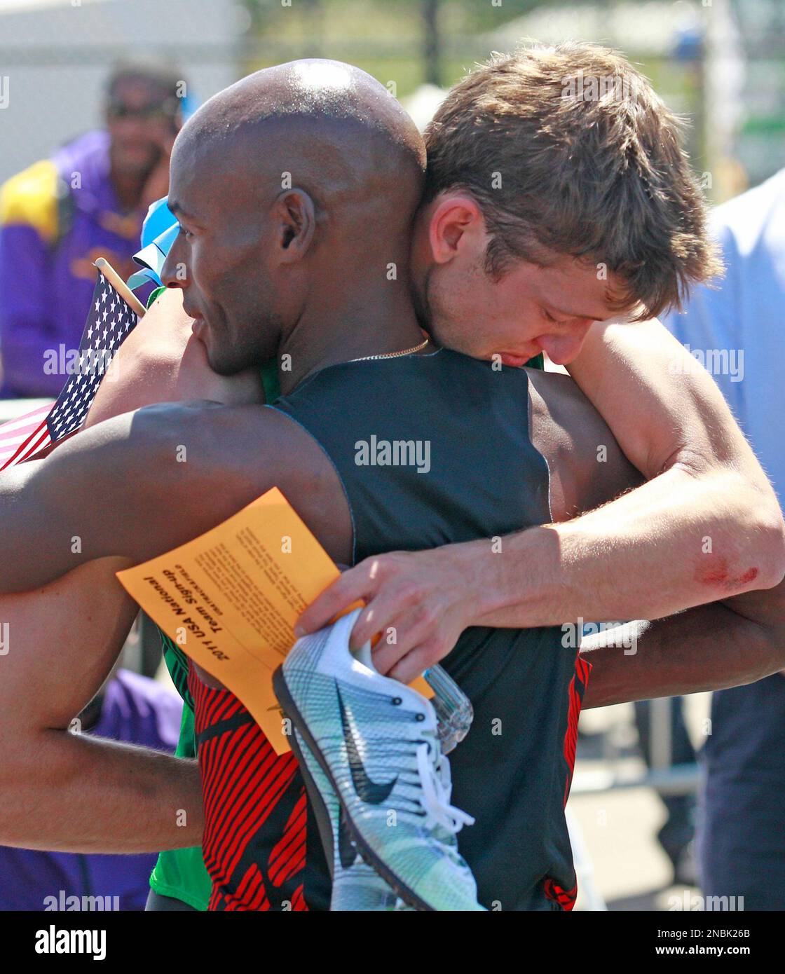 A tearful Andrew Wheating, right, is consoled by Bernard Lagat after ...